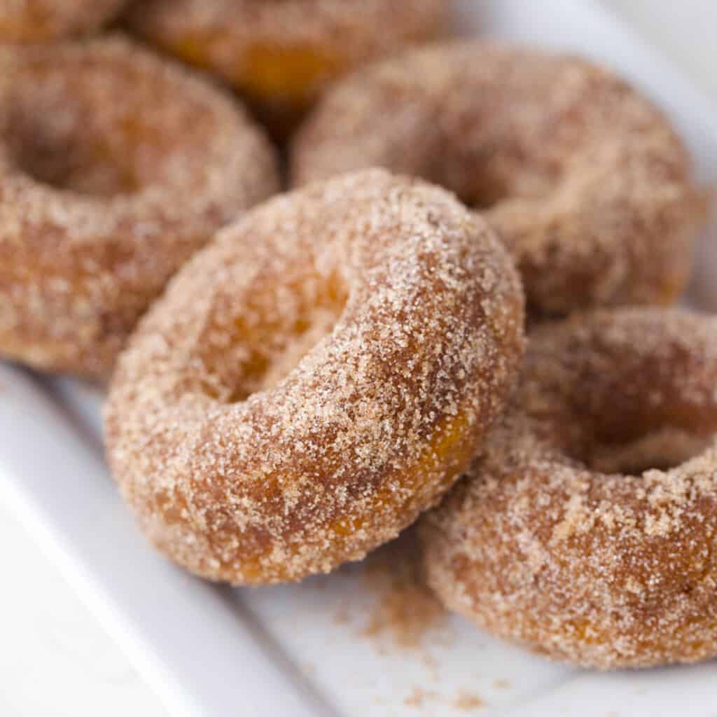 Pink Frosted Cake Mix Donuts Recipe in a Donut Pan - Mom Loves Baking